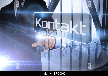 Businessman presenting the word contact in german against room with ...