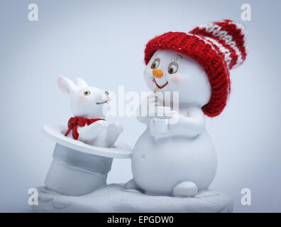 Cheerful snowman shows tricks Stock Photo - Alamy