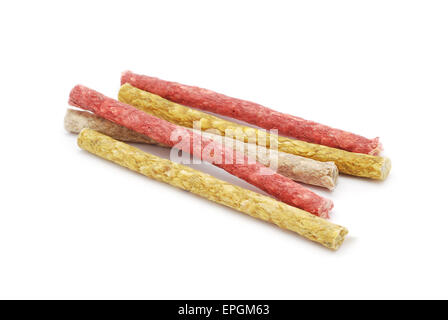 Dog chewing sticks on a white background. Treats for dogs Stock Photo ...