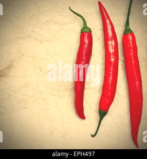 Three red hot chili peppers isolated over white background Stock Photo ...