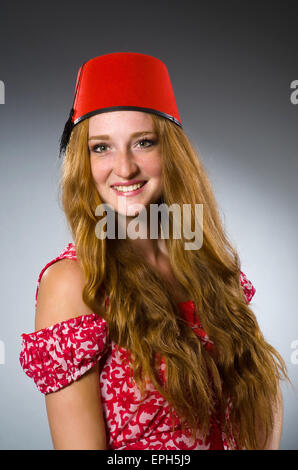 Woman wearing red fez hat Stock Photo - Alamy