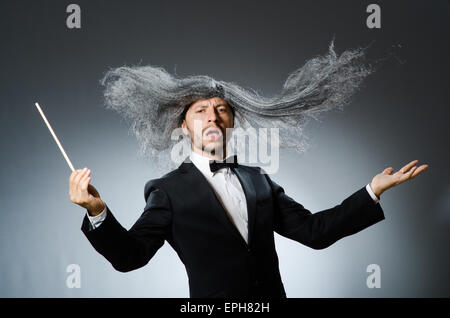 Funny conductor with long grey hair Stock Photo - Alamy