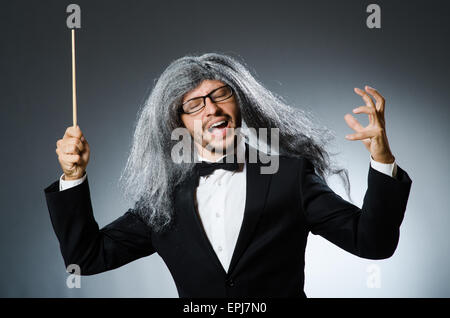 Funny conductor with long grey hair Stock Photo - Alamy
