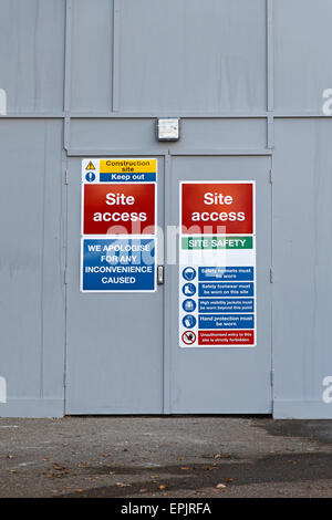 Construction site access door with warning signs Stock Photo - Alamy