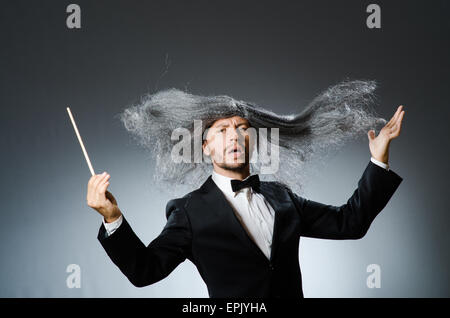 Funny conductor with long grey hair Stock Photo - Alamy