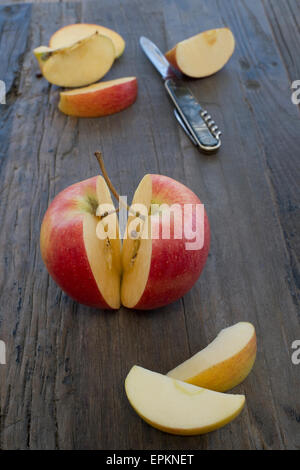 Sliced apple and pocket knife on dark wood Stock Photo - Alamy