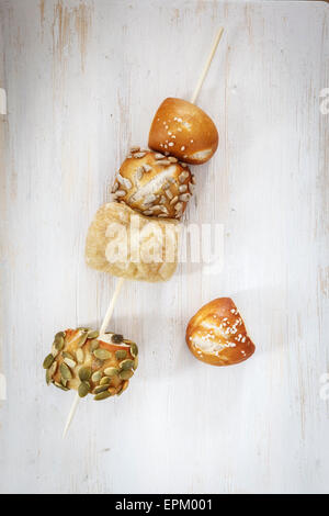 Different mini lye rolls, skewered Stock Photo - Alamy
