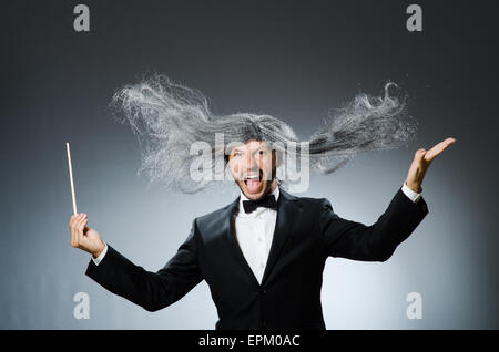 Funny conductor with long grey hair Stock Photo - Alamy
