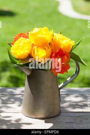 a bouquet of tulips on a garden table Stock Photo - Alamy