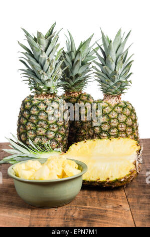fresh and ripe harvested pineapples, a tropical fruit with green leaves ...