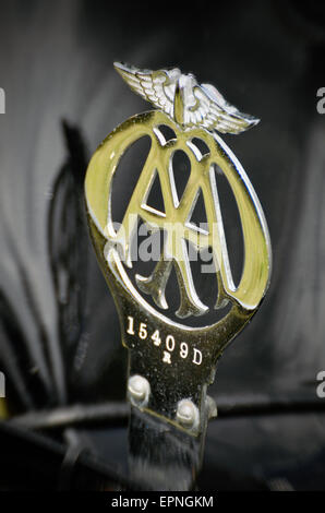Vintage brass AA Automobile Association badge logo on the front grill ...