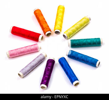 Colorful thread rolls in a circle on a white background Stock Photo - Alamy