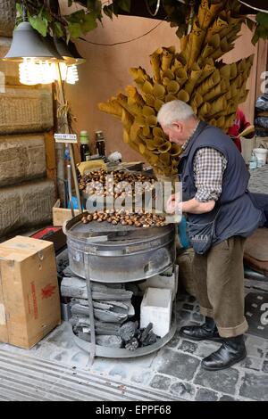 Man roasting chestnuts, Rome. Italy Stock Photo - Alamy