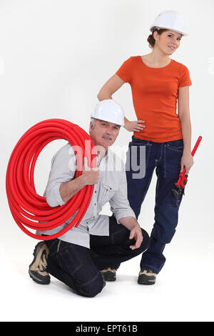 renovation apprentice posing and smiling with teacher Stock Photo - Alamy