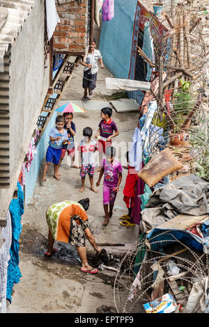 Mumbai India,Dharavi Kumbhar Wada,slum poverty poor resident,male boy child kid home watching tv ...