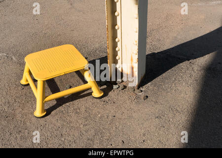 Yellow step stool at rail road depot Stock Photo - Alamy