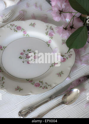 Elegant place setting with antique floral china, silverware, crystal ...