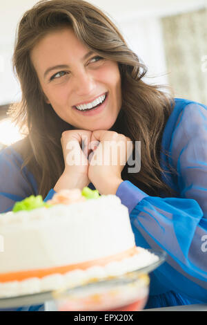 Holidays and celebration. Excited woman celebrating birthday, blowing ...
