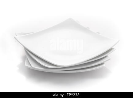 A stack of square white plates isolated on black background with copy ...