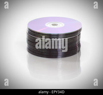 On a white background is a stack of CD / DVD disk with a computer mouse ...