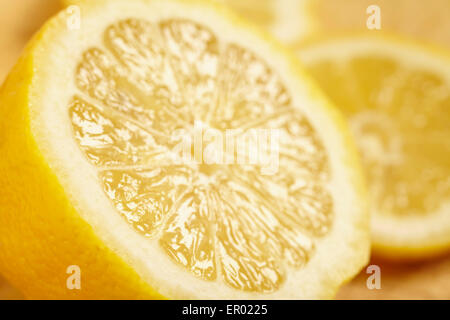 Acid and yellow fruit. Half lemon on a blue wood Stock Photo - Alamy