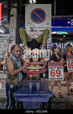 Contortionist child performing at a night street venue. Extreme ...