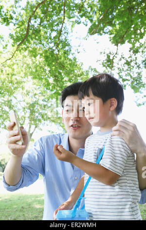 Japanese parent and child collecting insects Stock Photo - Alamy