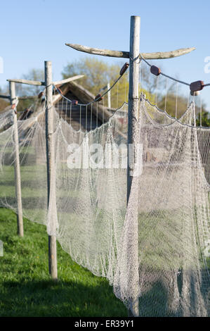 Old style fishing net hanging to dry near seashore Stock Photo - Alamy