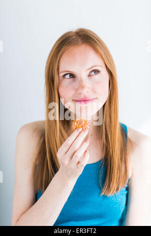 Woman eating pastry Stock Photo - Alamy