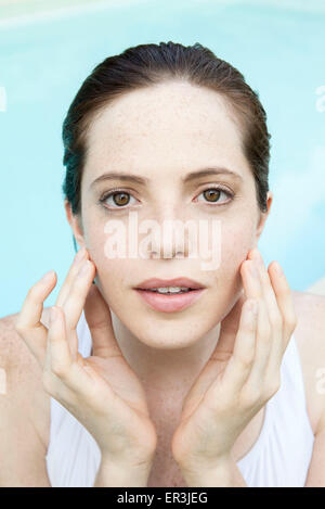 Beauty young woman touches her face with her hands. Young pretty lady ...
