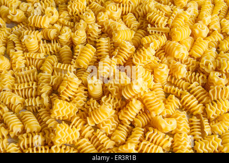 Uncooked radiatori pasta background Stock Photo - Alamy