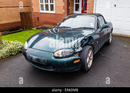 Car with damage to front wing on drive Stock Photo - Alamy