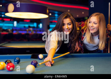 Friends hanging out at the pool table Stock Photo - Alamy