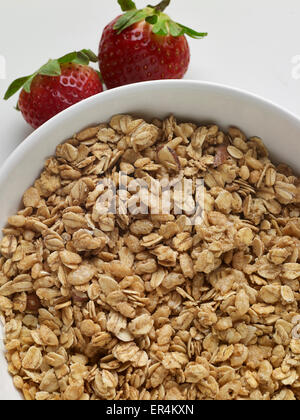 Musli (granola) close up with spoon, dry fruits, nuts and cereals in ...
