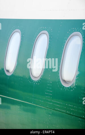 Windows on fuselage of airplane. Plane against clear sky with copy ...