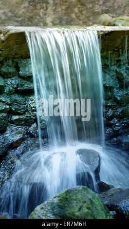 Close up of a wild stream that flows through the barrier. Small natural ...