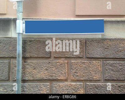 A blue information sign on a metal wire fence with a white graphic icon ...
