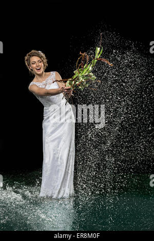 excited bride holding wedding bouquet and showing win gesture isolated ...