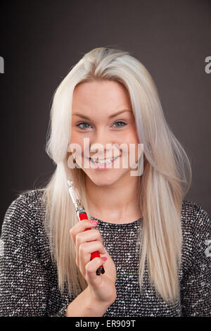 Happy vaper girl with vaping device in hand.Quit smoking nicotine ...