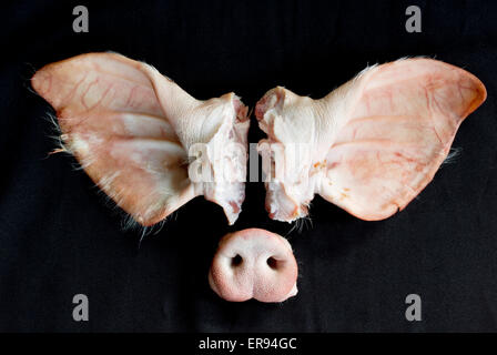 Close up of raw pig's ear with species at plate on table Stock Photo ...