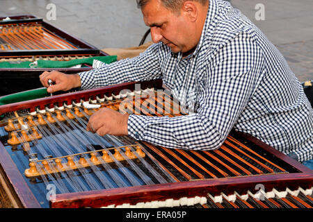 Stefan Fieraru tuning a Cimbalon, a concert hammered dulcimer Stock ...
