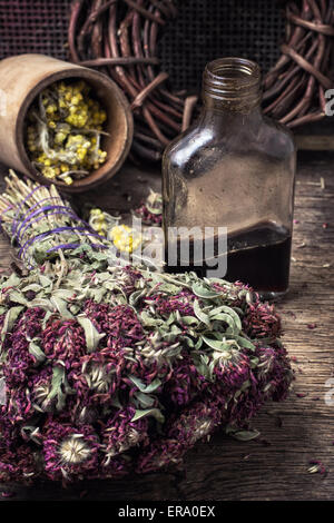 Glass bottle of licorice root essential oil with liquorice fiber on ...