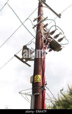 Overhead electricity power lines supported by wooden utility poles ...