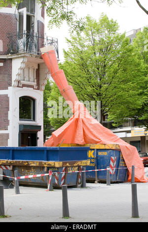 Rubbish Chute On Building Site taking the waste into a skip at the ...