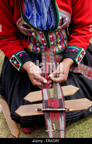Peruvian indigenous Quechua woman weaving a textile with the ...