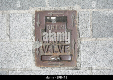 street water valve cover with instructions on how to open Stock Photo ...