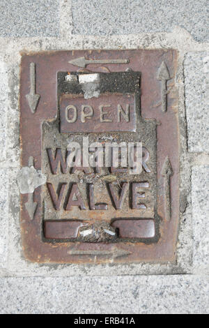 street water valve cover with instructions on how to open Stock Photo ...