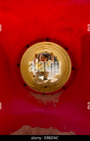 A small boy playing in a sandpit in a park during summer Stock Photo ...
