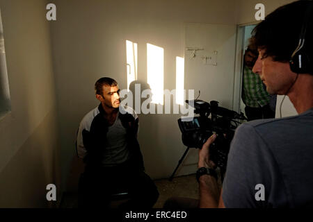 Israeli filmmaker Itai Anghel filming a Kurdish fighter of the People's ...