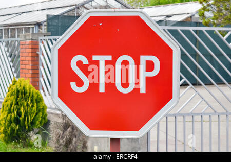 Traffic stop sign at an intersection with speed bump Stock Photo - Alamy